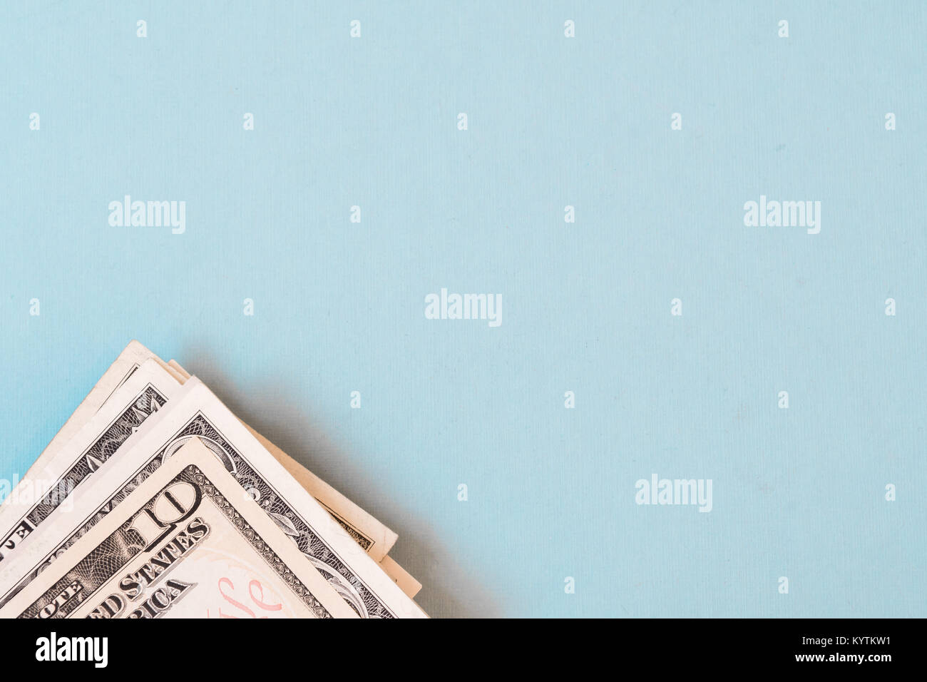 currency on turquoise with copy space Stock Photo - Alamy