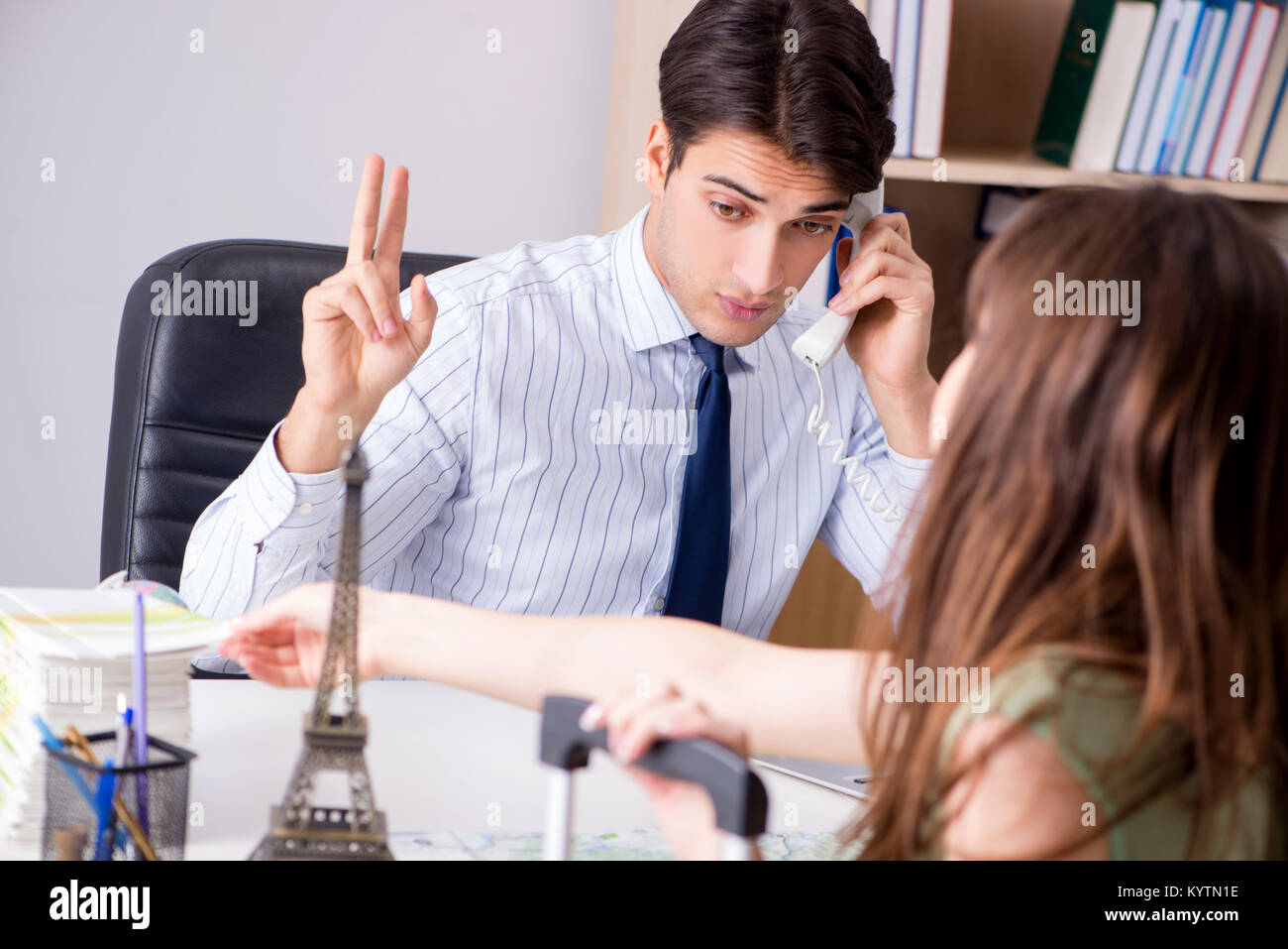 Male travel agent with customer in agency Stock Photo - Alamy