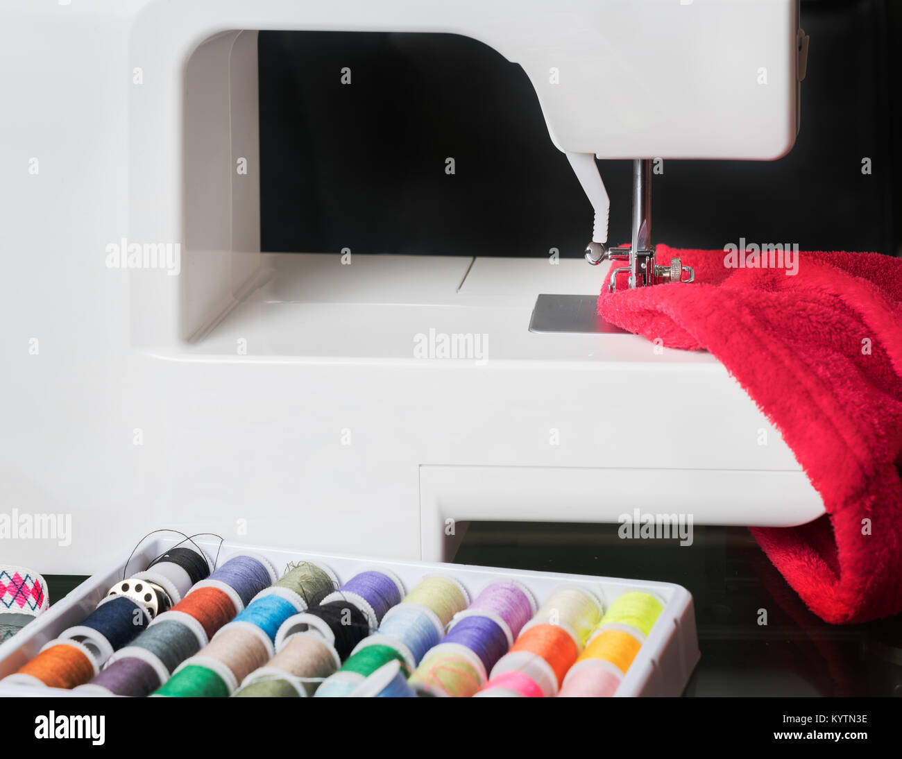 sewing machine and red cloth, sewing process in the phase of ...