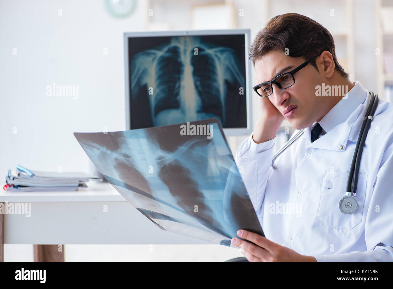 Doctor radiologist looking at x-ray images Stock Photo - Alamy