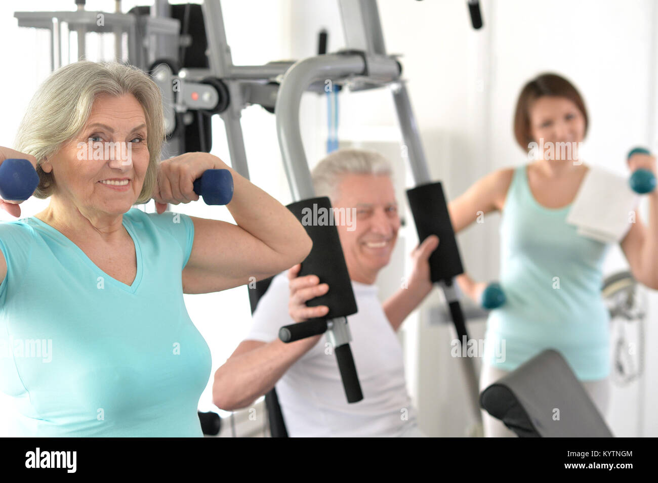 Active smiling people exercising in gym Stock Photo - Alamy