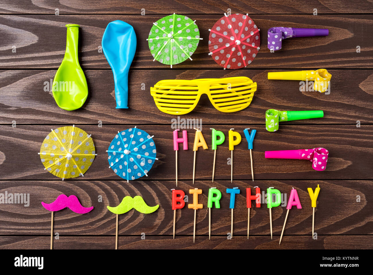 Birthday accessories on wooden table Stock Photo - Alamy