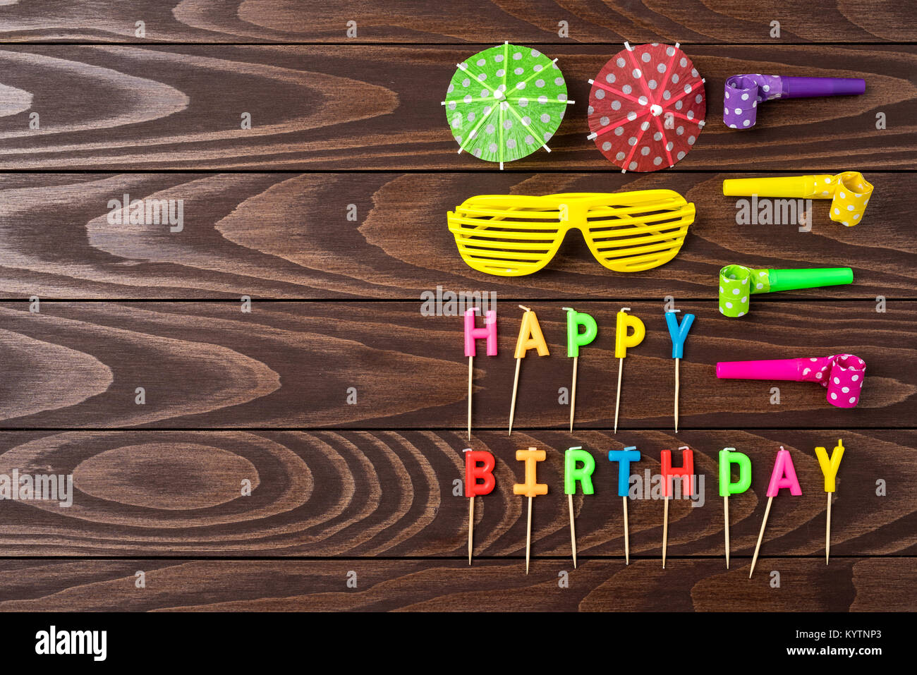 Birthday accessories on wooden table Stock Photo - Alamy