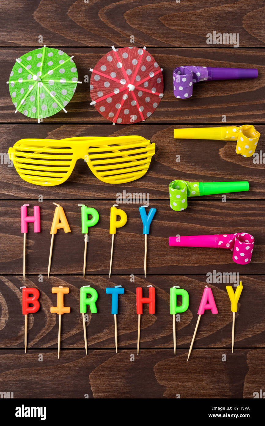 Birthday accessories on wooden table Stock Photo - Alamy