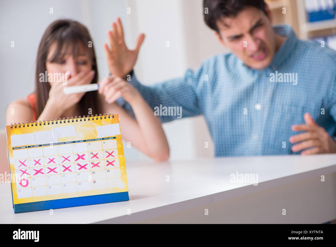 Young family in pregnancy planning concept with ovulation calendar ...
