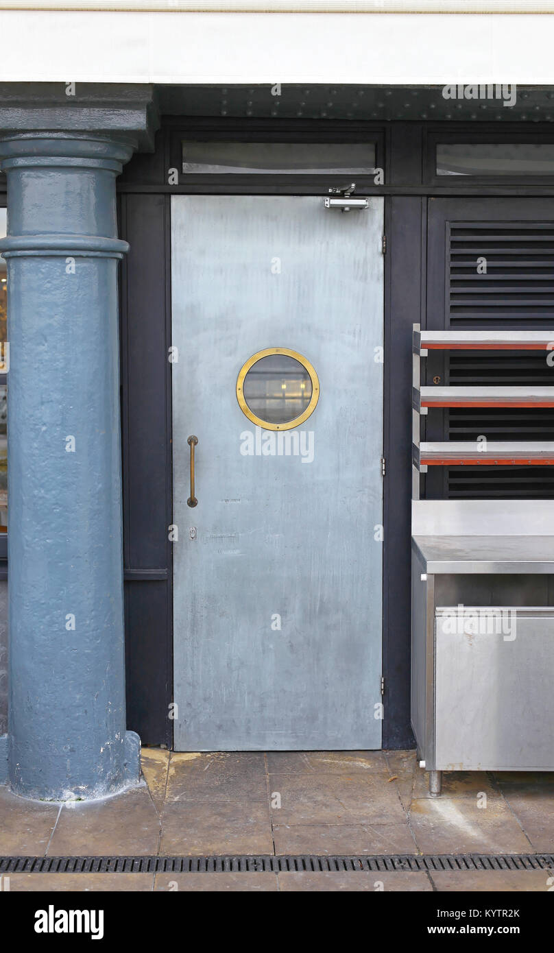 Silver Metal Door With Small Round Window Stock Photo - Alamy