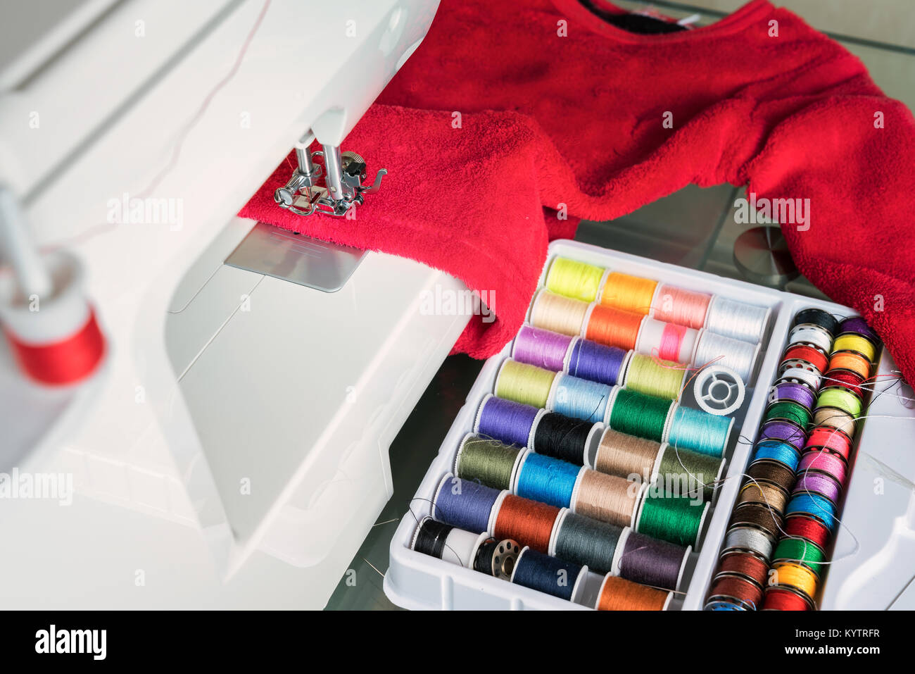 sewing machine and red cloth, sewing process in the phase of ...