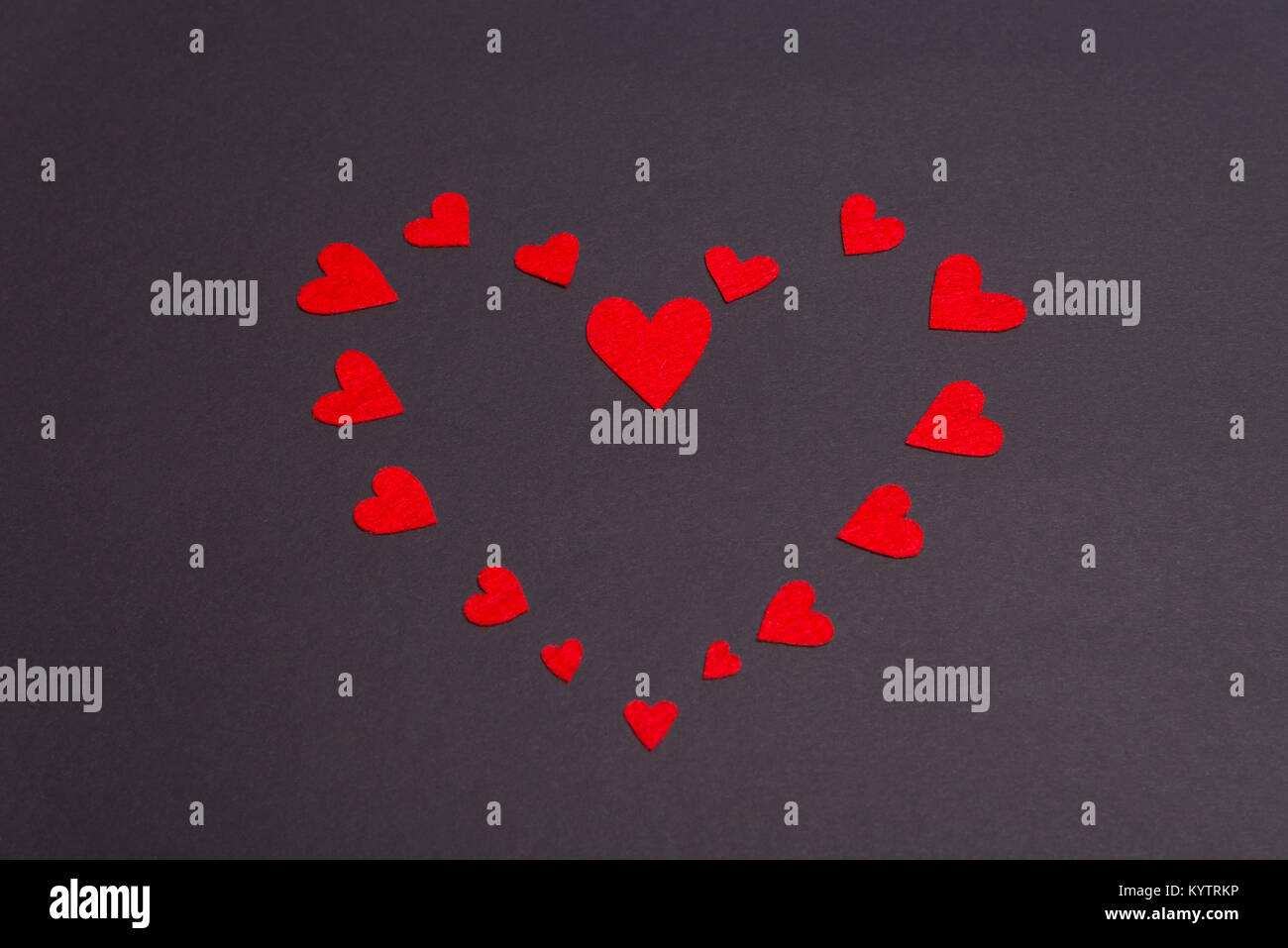 Red hearts, different size, laid out against a dark background Stock ...