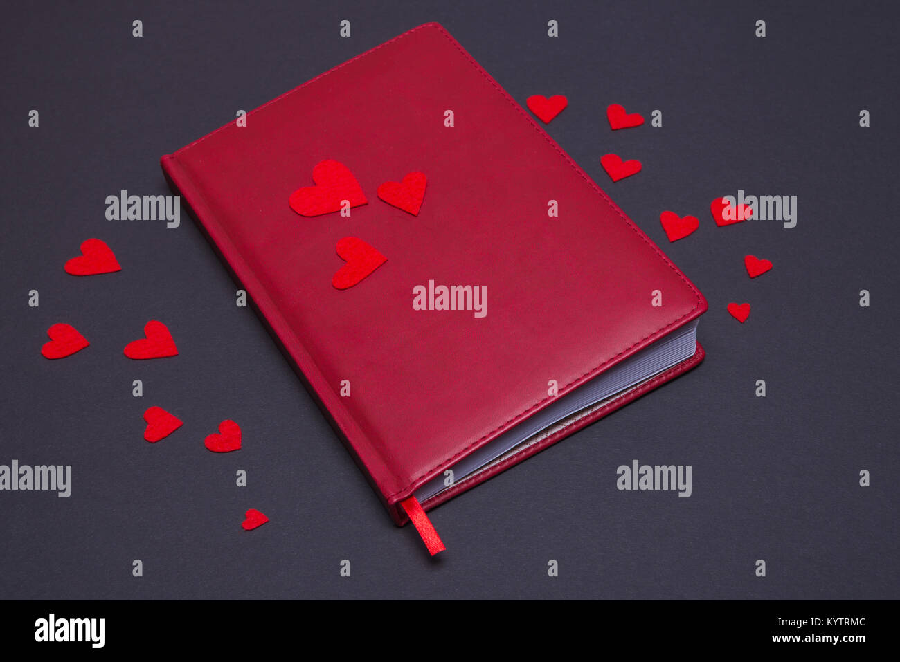 Diary with red hearts on a dark background Stock Photo - Alamy