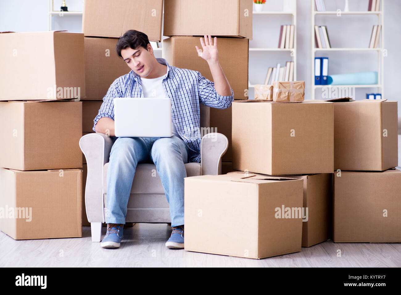 Young man moving in to new house with boxes Stock Photo - Alamy