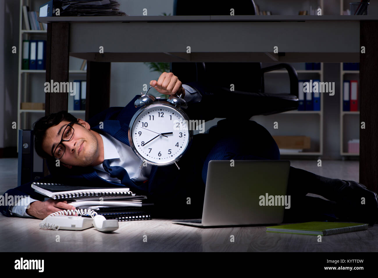 Businessman working overtime long hours late in office Stock Photo - Alamy