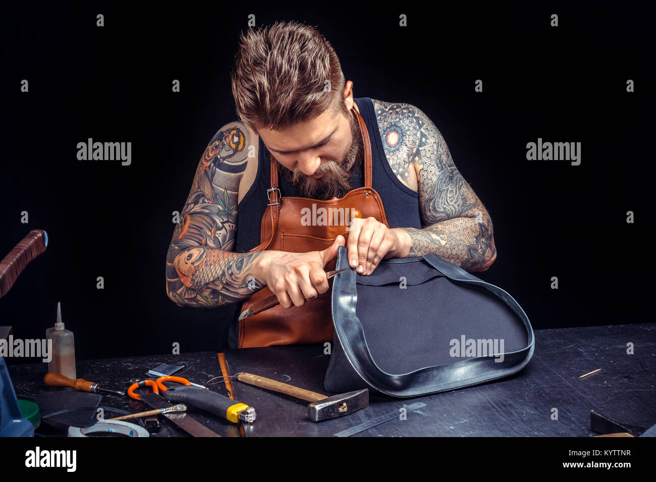 Leather Currier cutting leather outlines for his new production at his ...