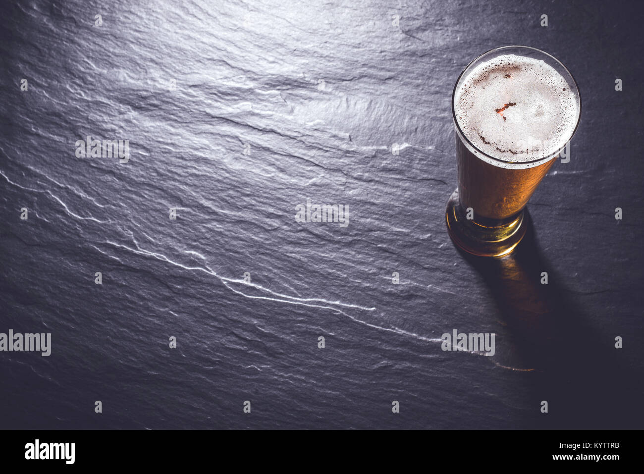 Beer glass on dark gray stone background. Top view Stock Photo - Alamy