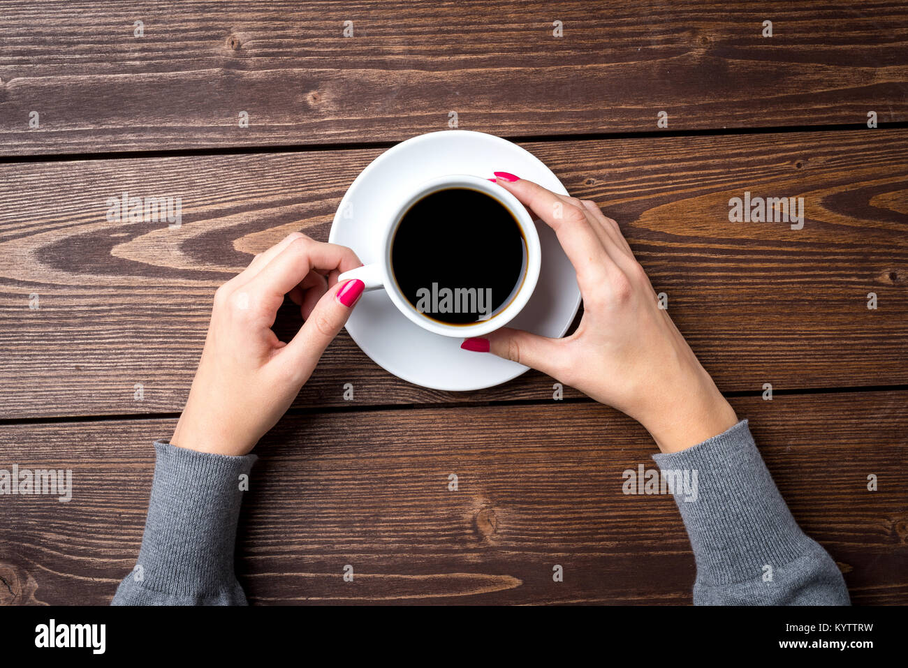 Overhead shot of woman's hands holding cup of coffee Stock Photo - Alamy