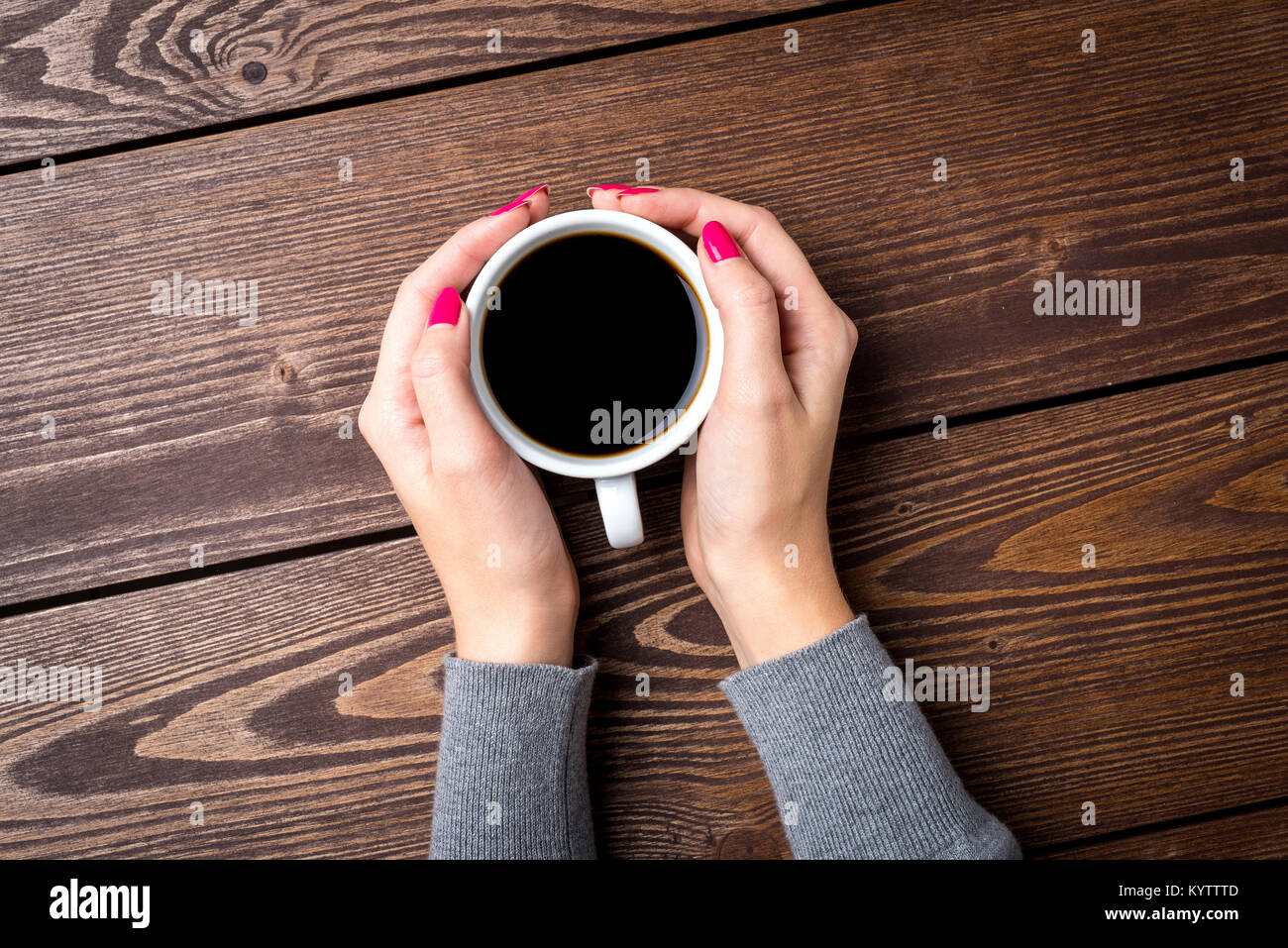 Overhead shot of woman's hands holding cup of coffee Stock Photo - Alamy