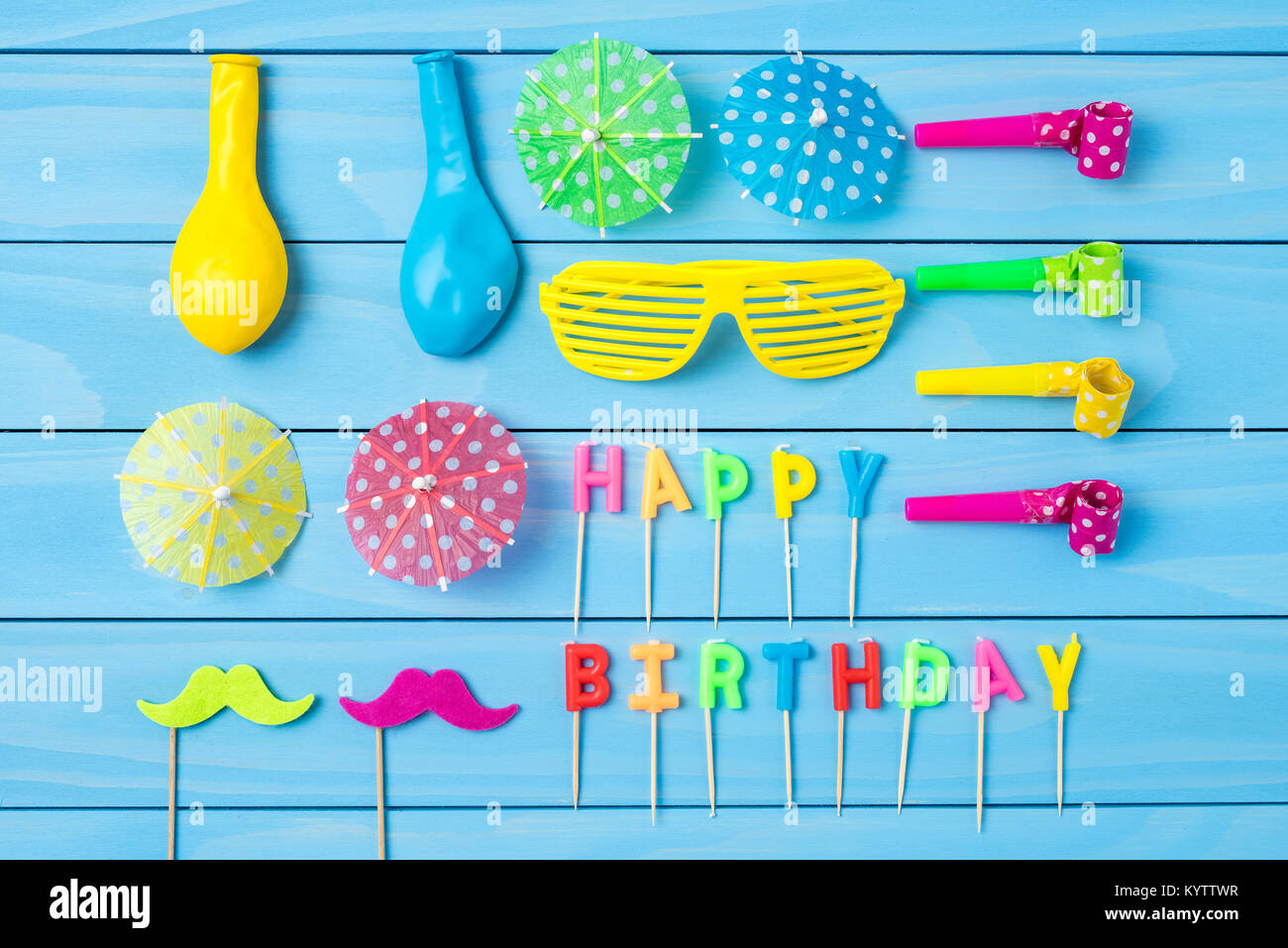 Birthday accessories on blue wooden table Stock Photo - Alamy