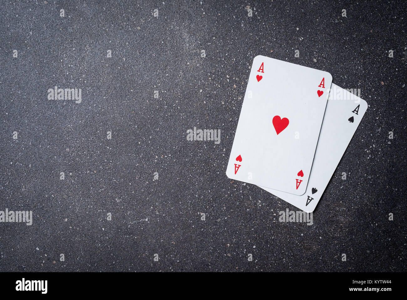Two aces on gray stone background Stock Photo - Alamy