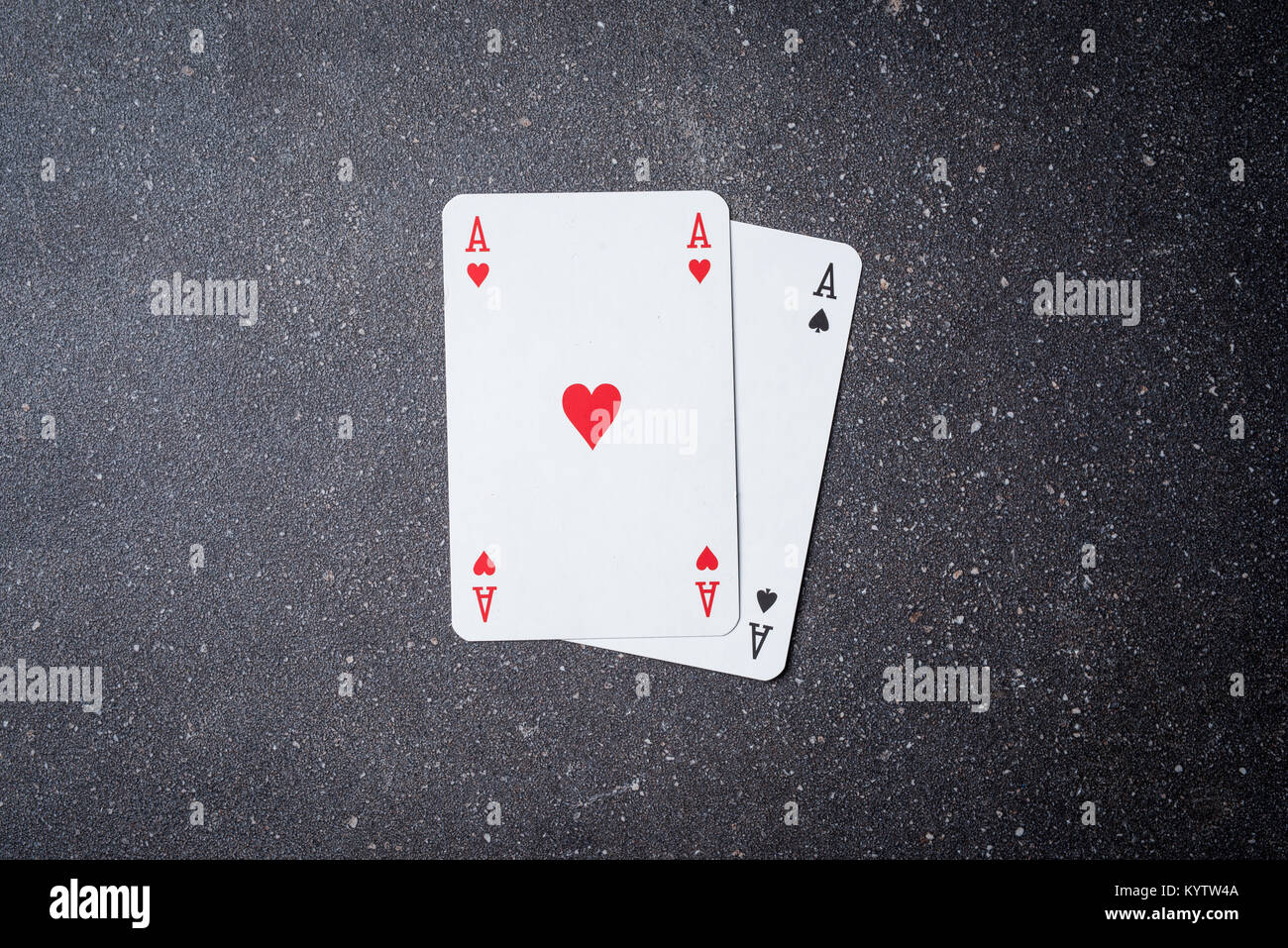 Two aces on gray stone background Stock Photo - Alamy