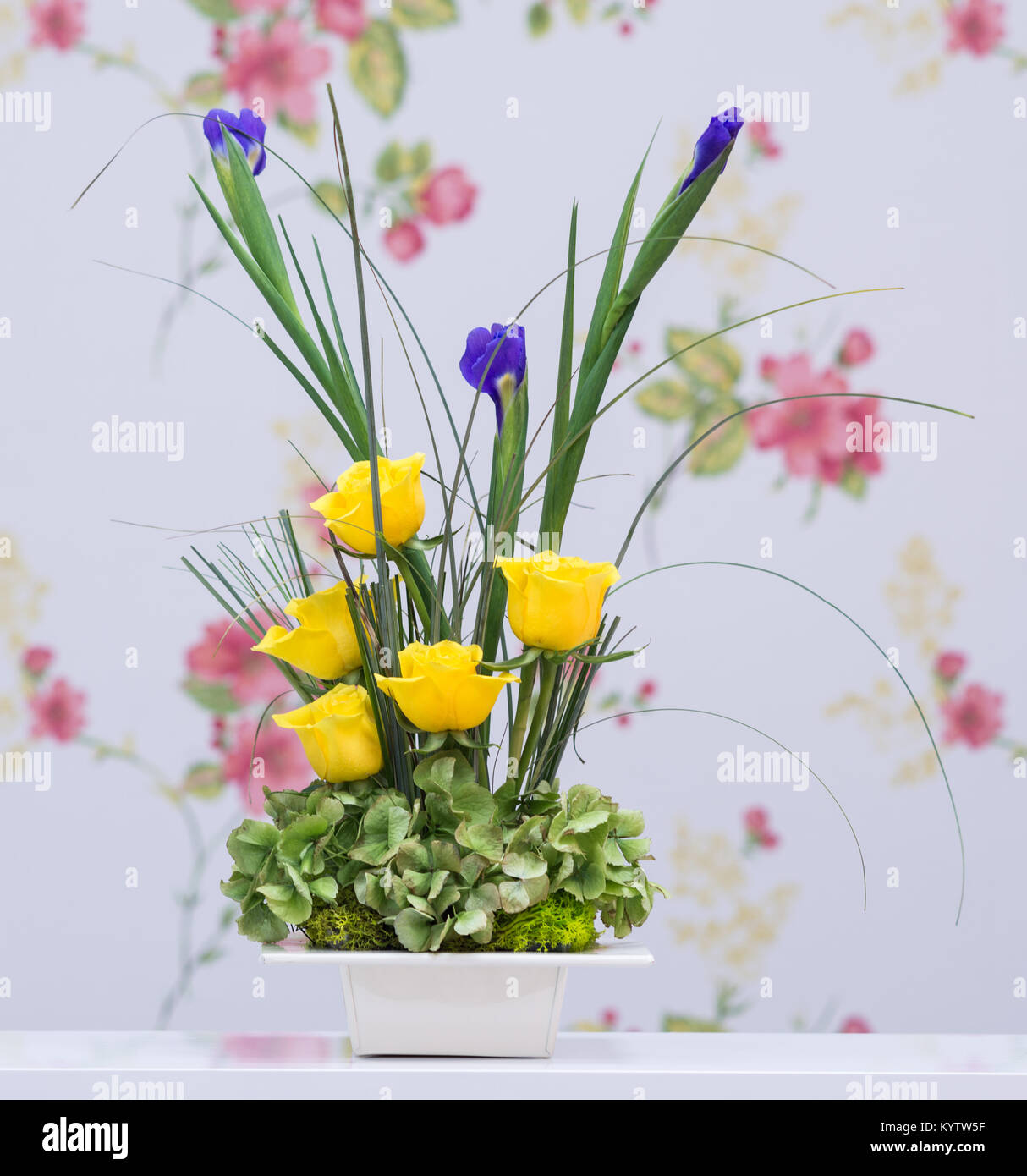 yellow roses and blue iris arrangement design Stock Photo - Alamy