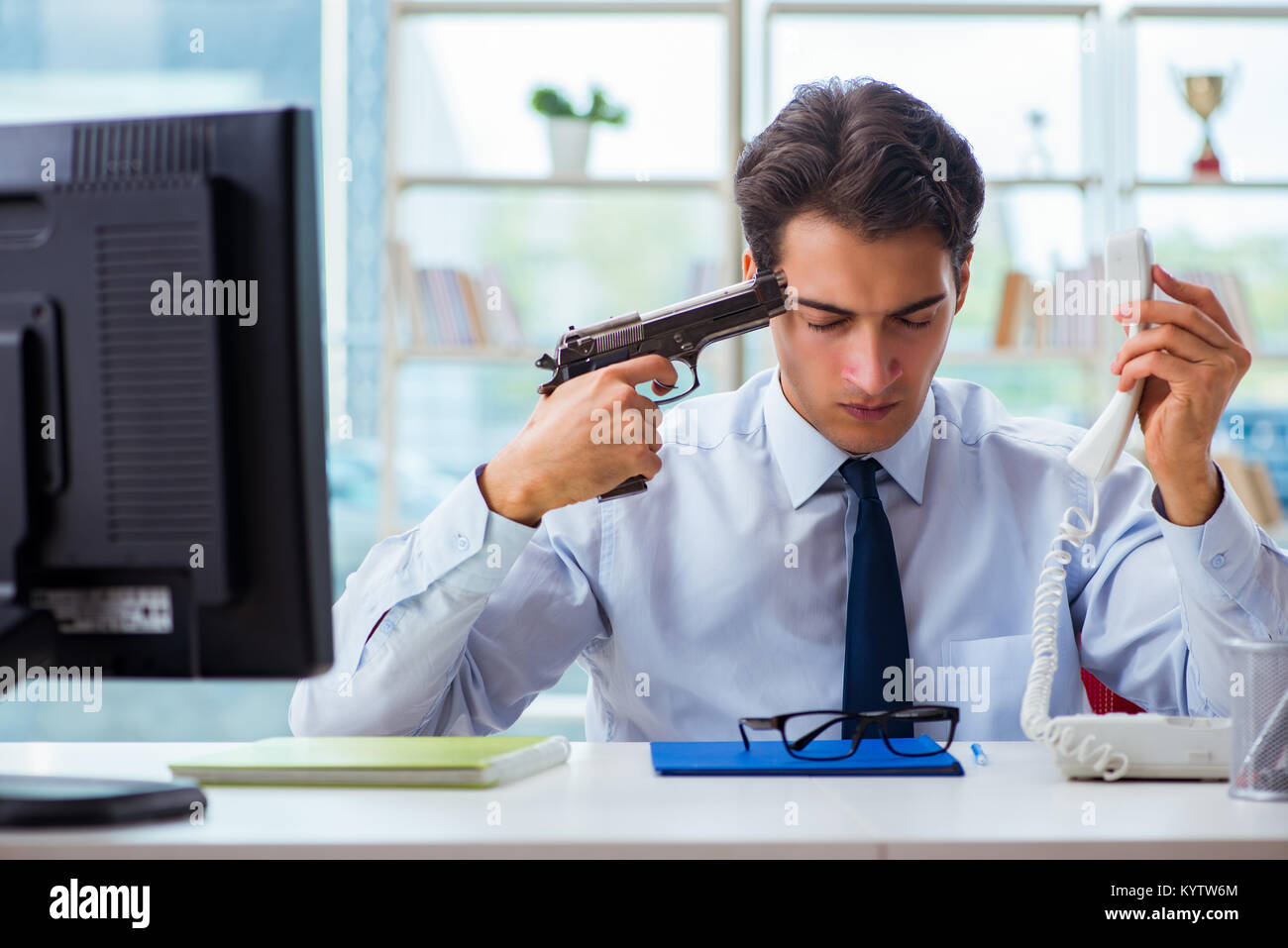 Angry businessman with gun thinking of committing suicide Stock Photo ...