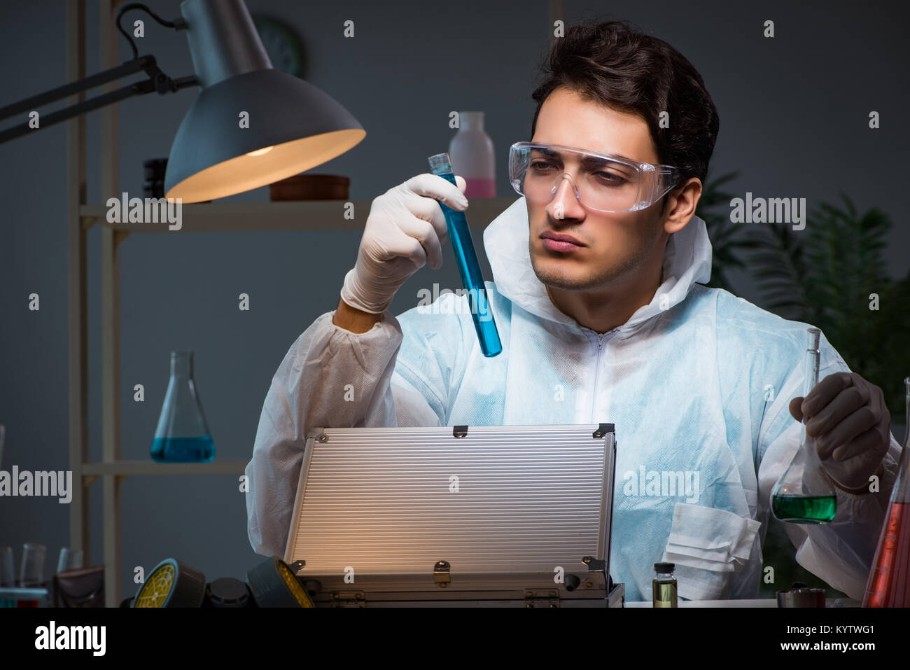 Forensic investigator working in lab looking for evidence Stock Photo ...