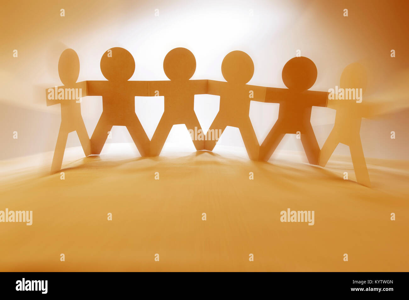 Team of paper chain people in a row holding hands Stock Photo - Alamy