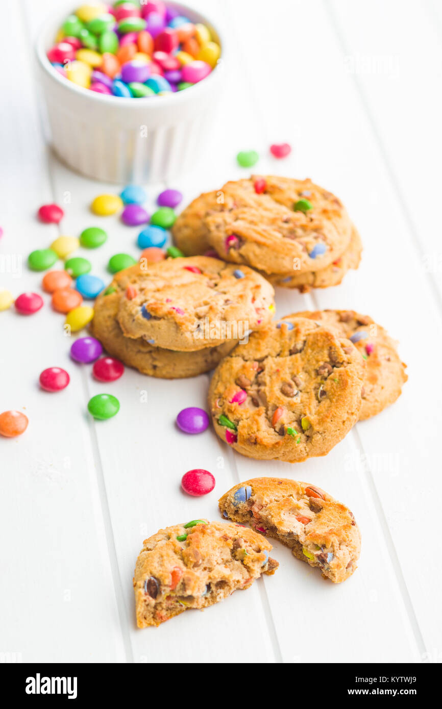 Sweet cookies with colorful candies on white table Stock Photo - Alamy