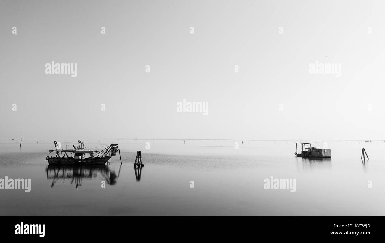Fishing boats inside Po river lagoon, Italy. Italian landscape. Minimal ...