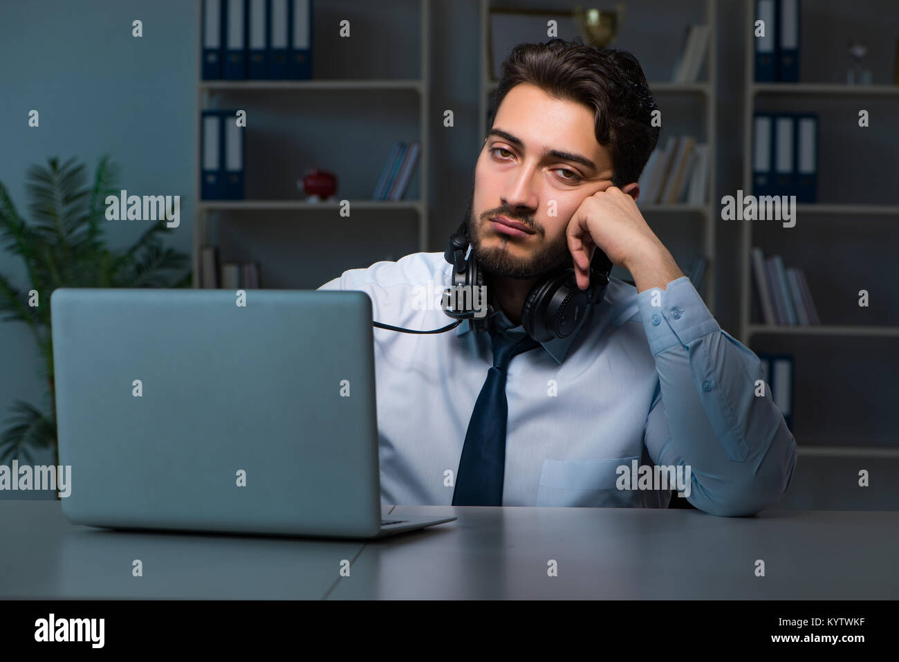 Young man in call center concept working late overtime in office Stock ...