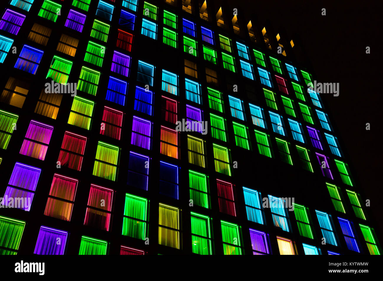 Colored windows texture. Windows illuminated by neon lights background ...