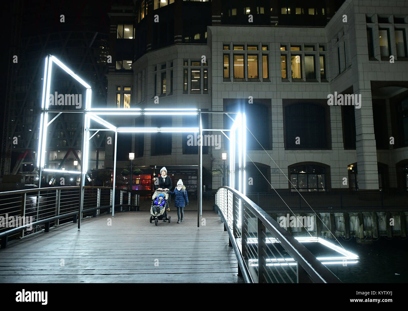 A family walk through the cube installation at the Canary Wharf winter ...