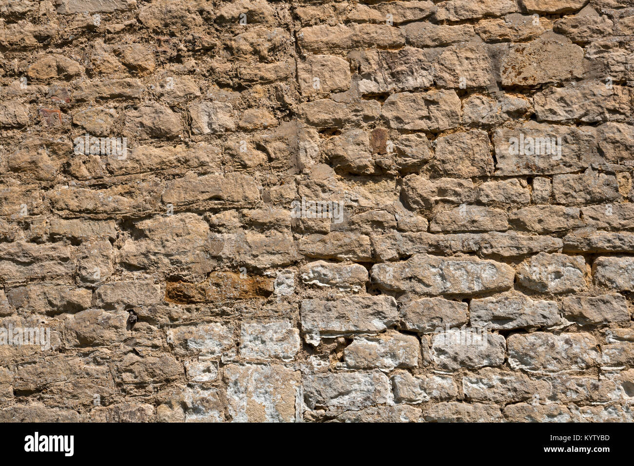 An old weathered stone wall needs repairs. Construction full frame ...