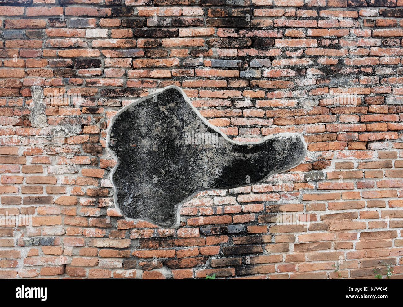 A cracked mark on the ancient bricked wall which is coincidently ...