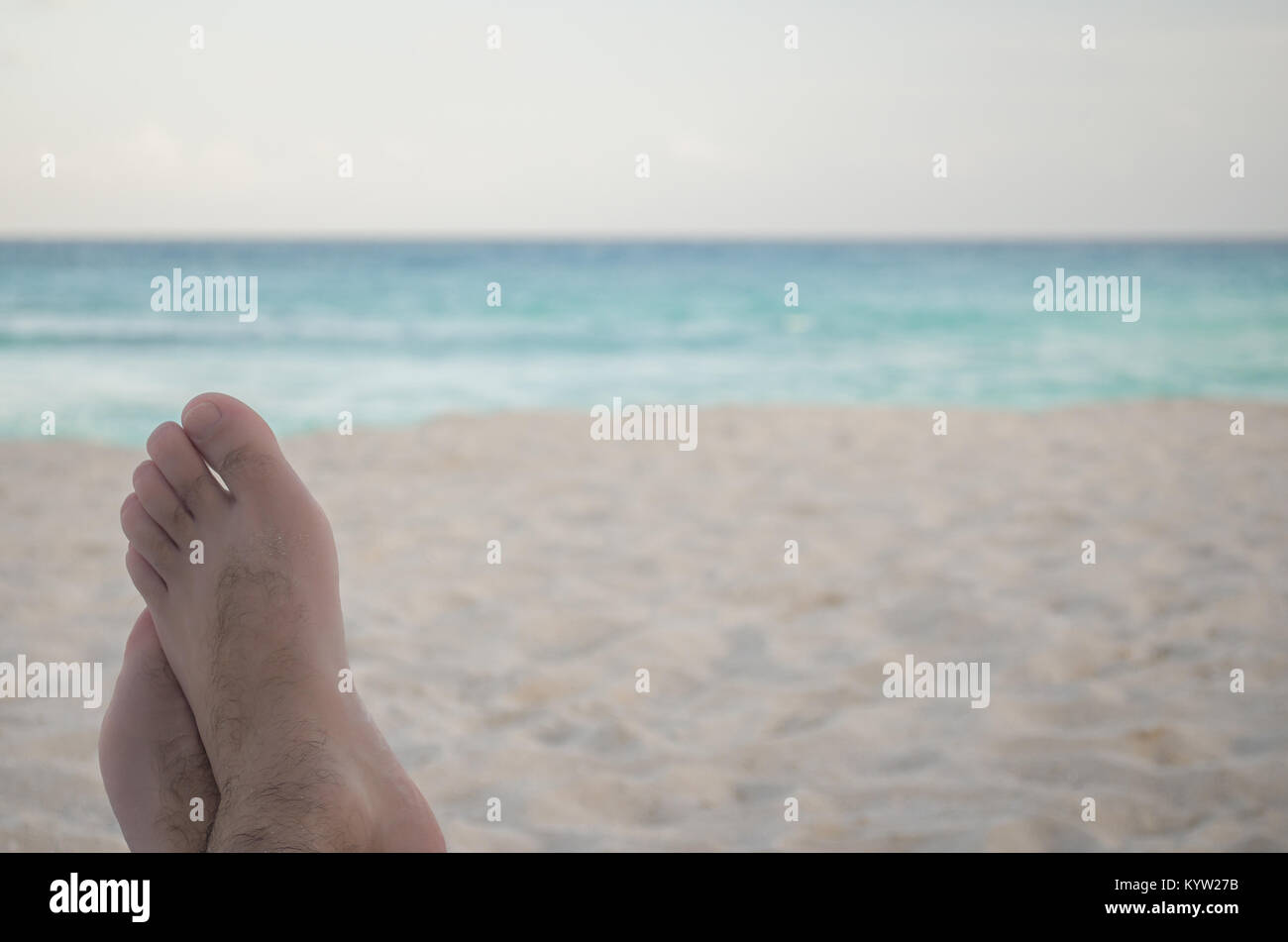 Relaxing with your feet up on a beach chair overlooking the blue ...