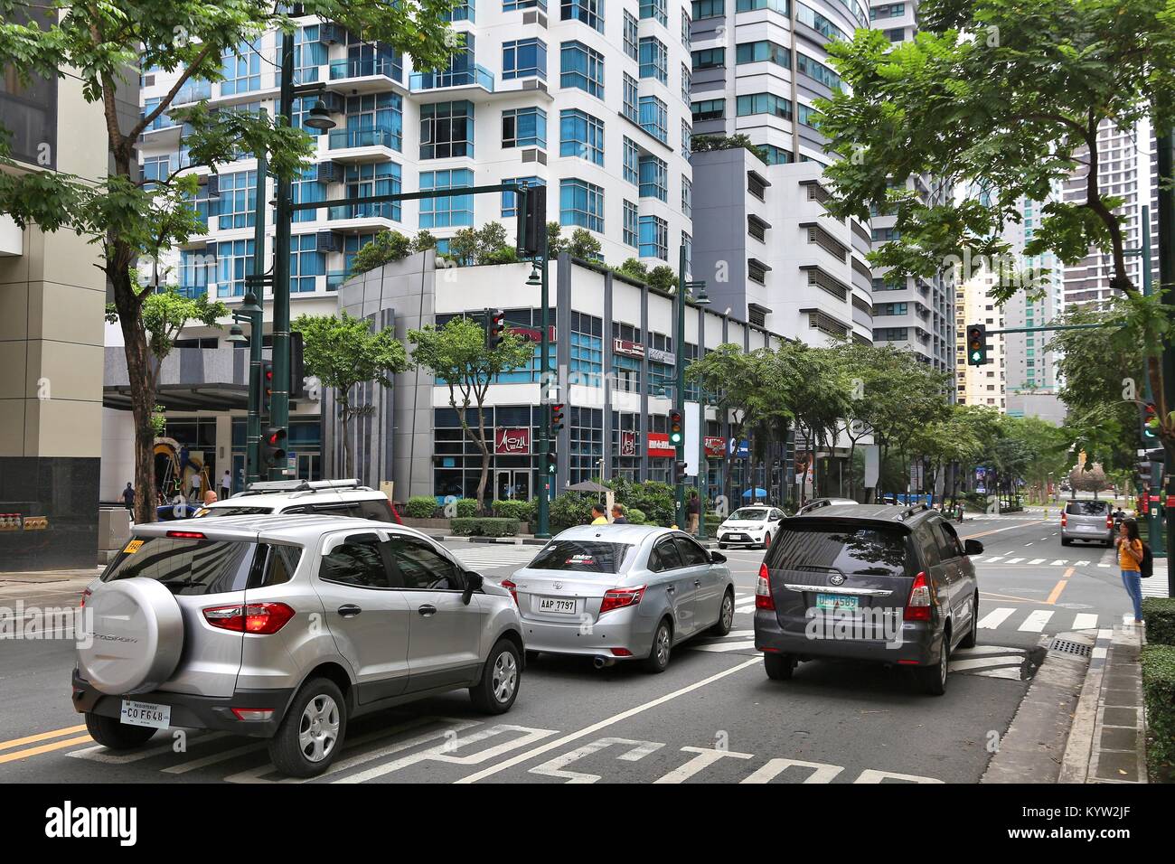 MANILA, PHILIPPINES - DECEMBER 8, 2017: People drive in Bonifacio ...