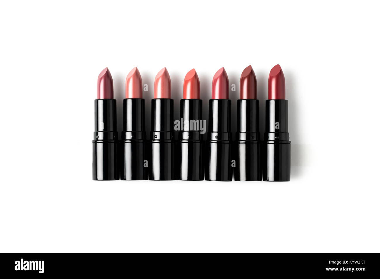 top view of lipsticks lying on white tabletop placed in row Stock Photo ...