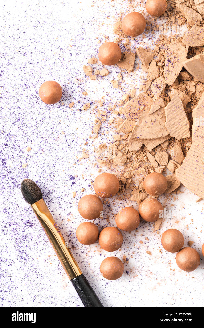 top view of crushed cosmetic powder with brush on white table Stock ...