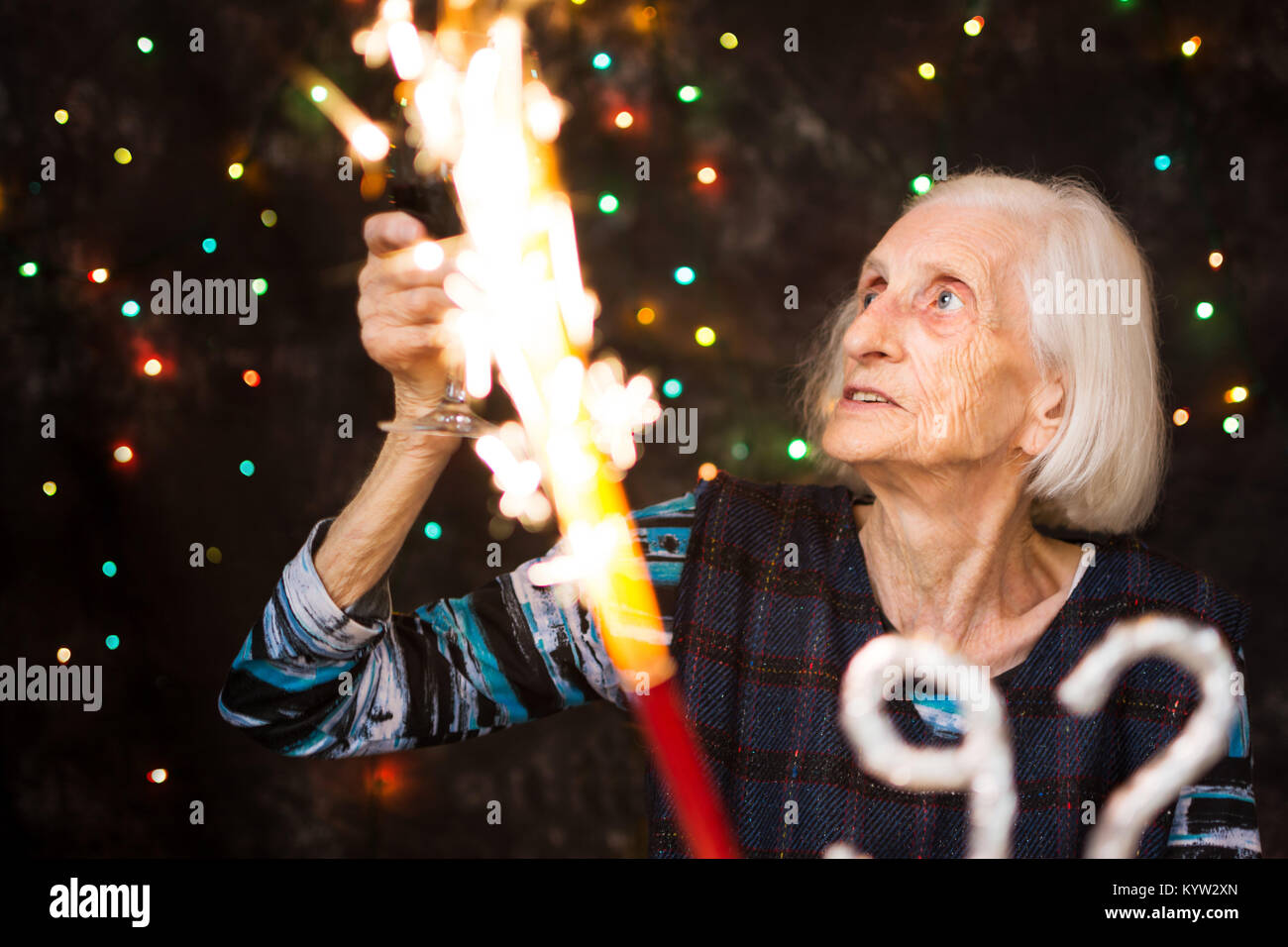Senior woman holding a toast on her birthday party Stock Photo - Alamy