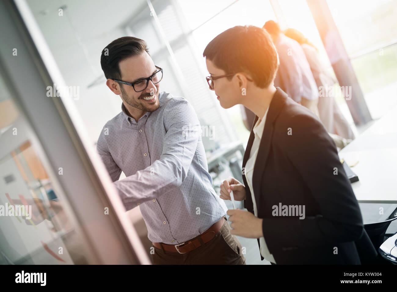 Happy colleagues casual chat at the office Stock Photo - Alamy