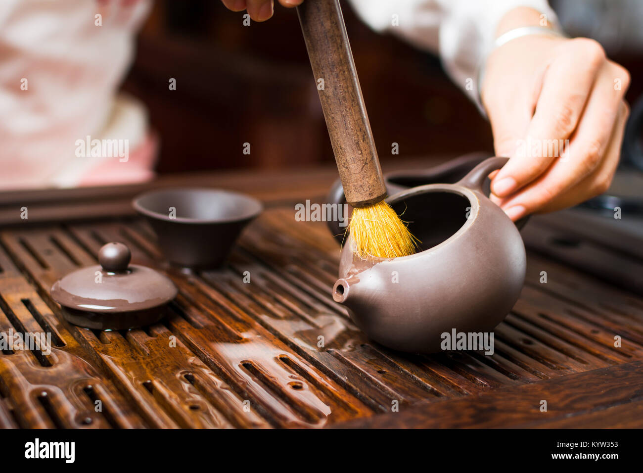 Female brushing tea kettle during during traditional Chinese tea ...
