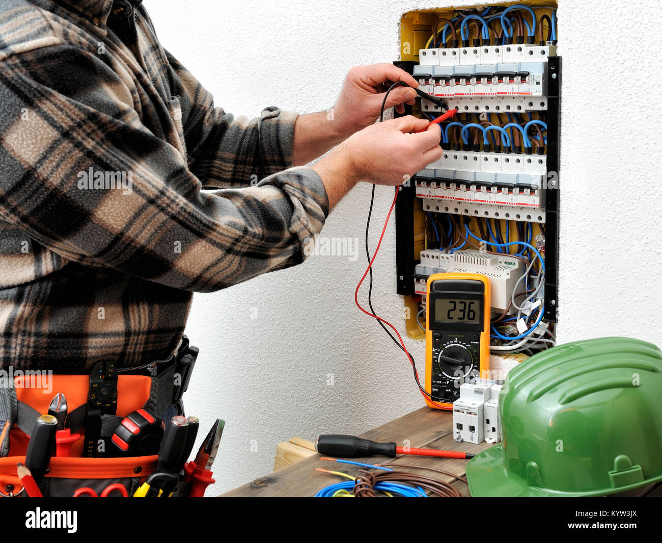 Technical electrician measures the voltage of a circuit breaker of a ...