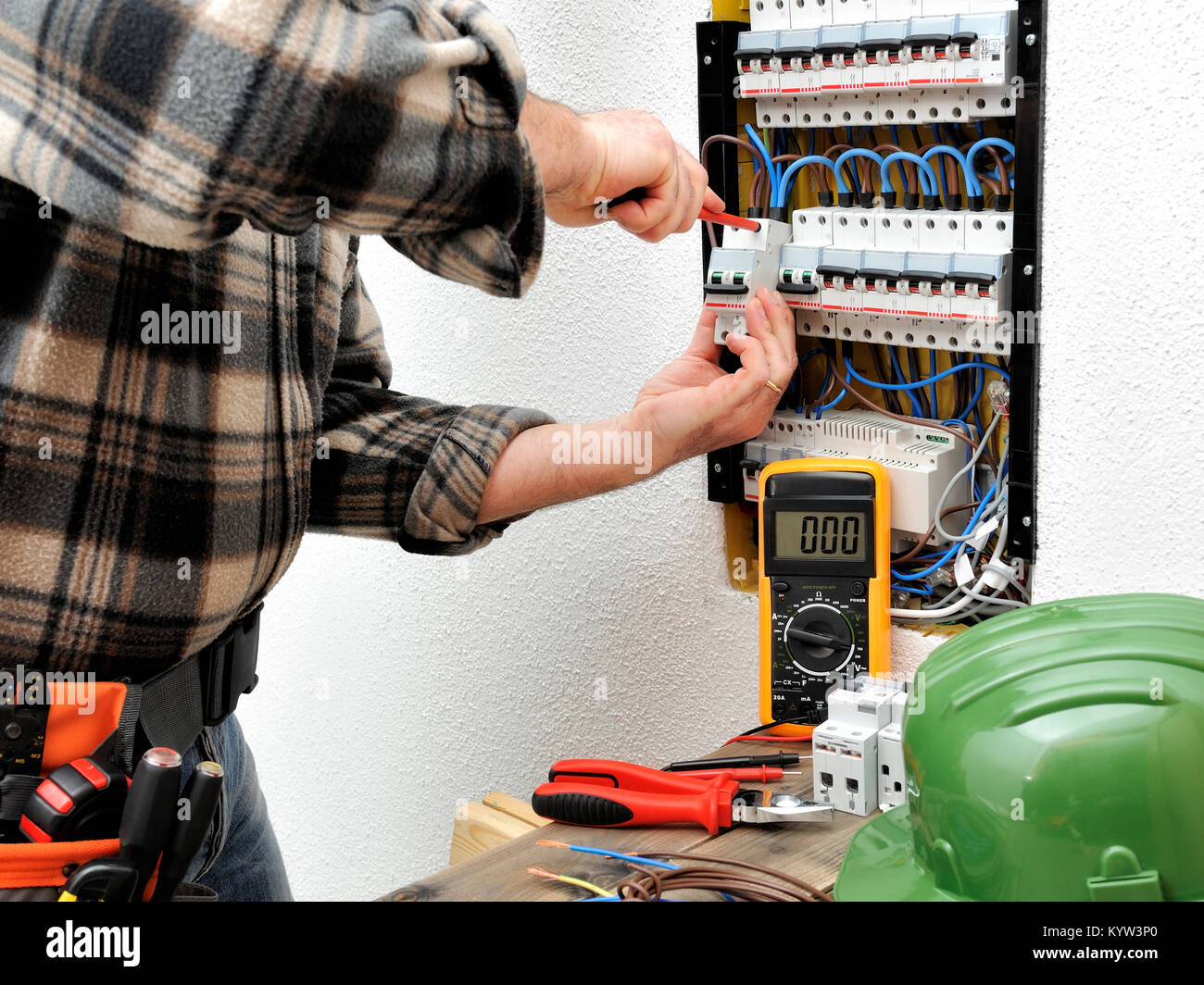 Technical electrician fixing the cable into the terminal of a circuit ...
