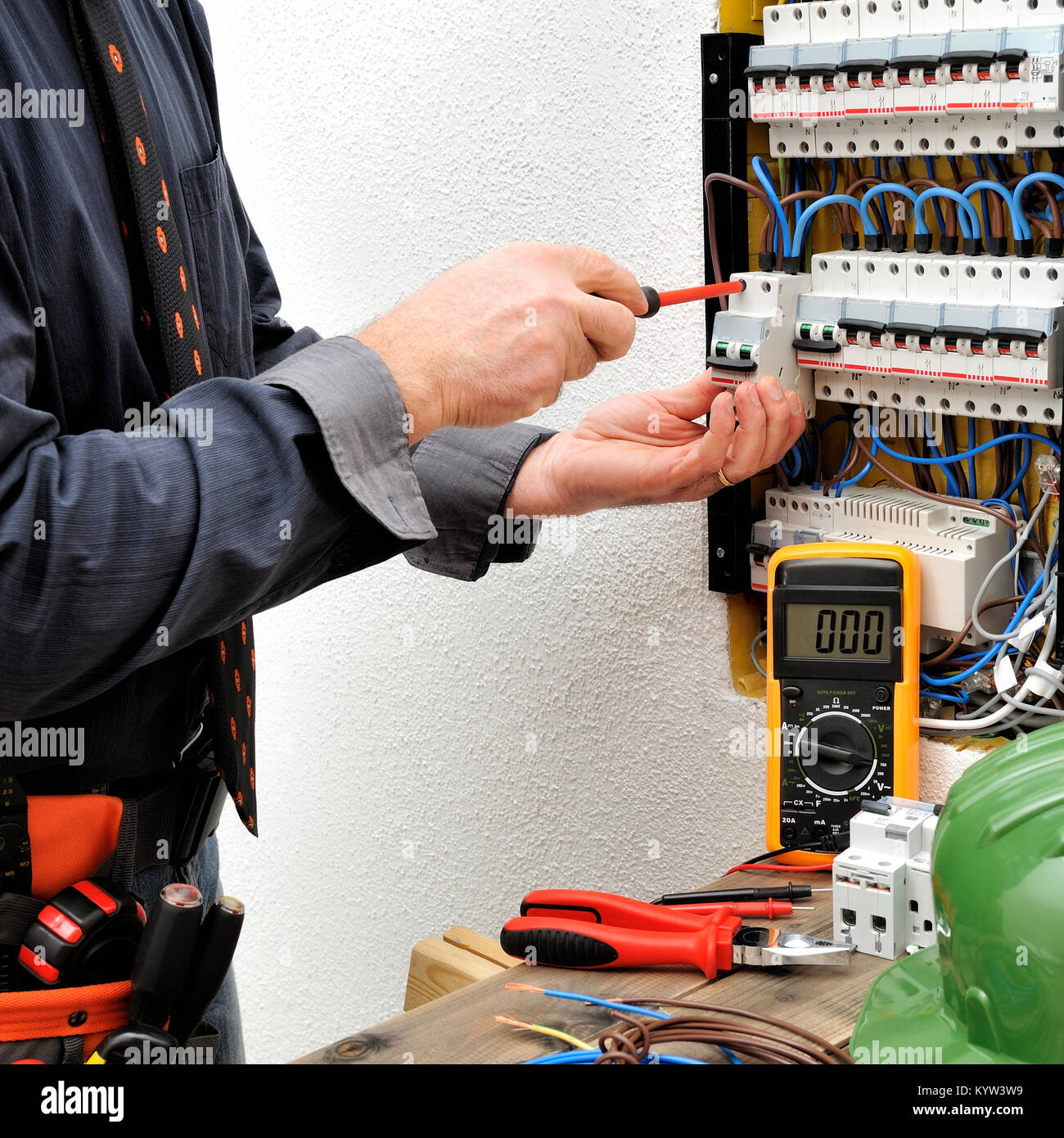 Elegant technical electrician fixing the cable into the terminal of a ...