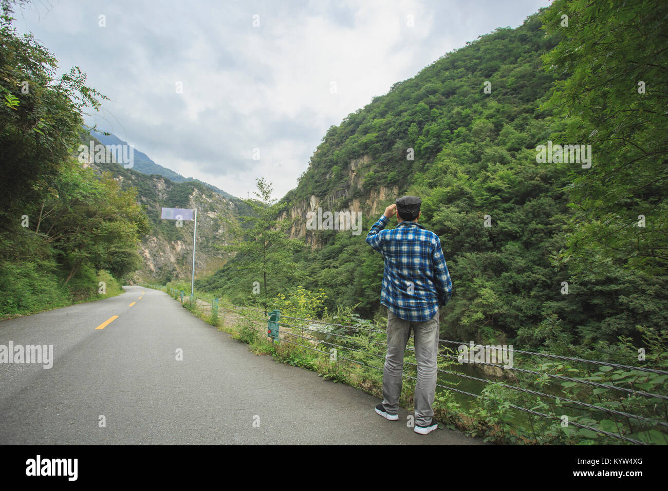 A man's back, Looking up at the valley scenery Stock Photo - Alamy