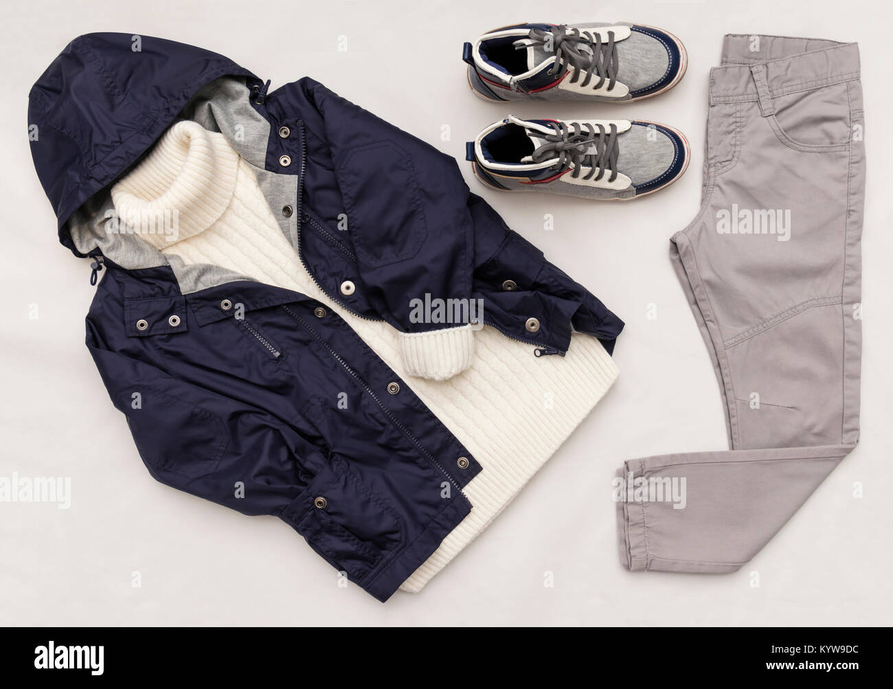 Top view fashion trendy look of kids clothes on white wooden background ...