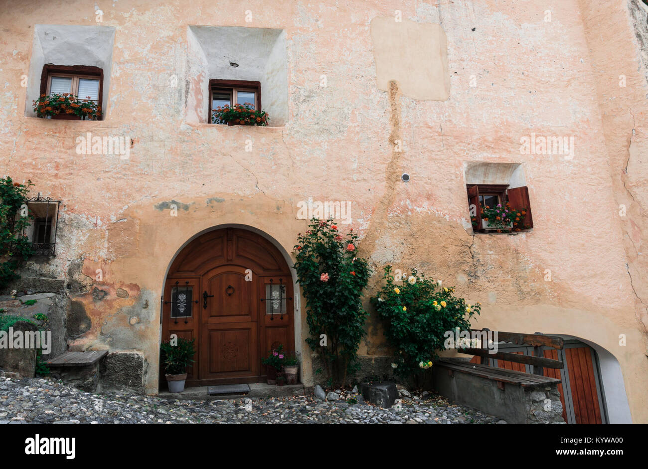 house front in Scuol in the traditional Engadine architecture style ...