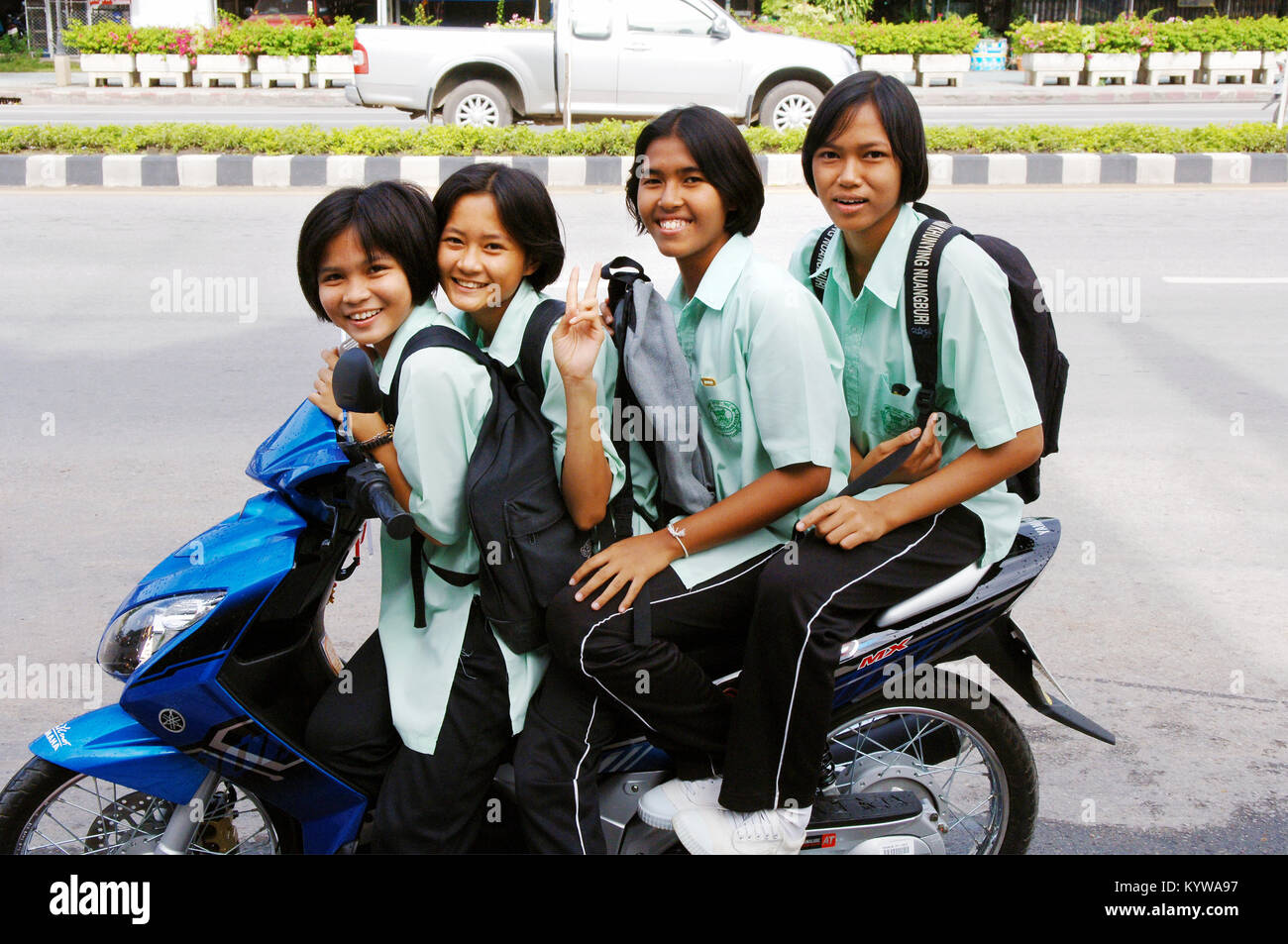 4 Primary school pupils on a motorbike - Cha-Am - Thailand Stock Photo ...