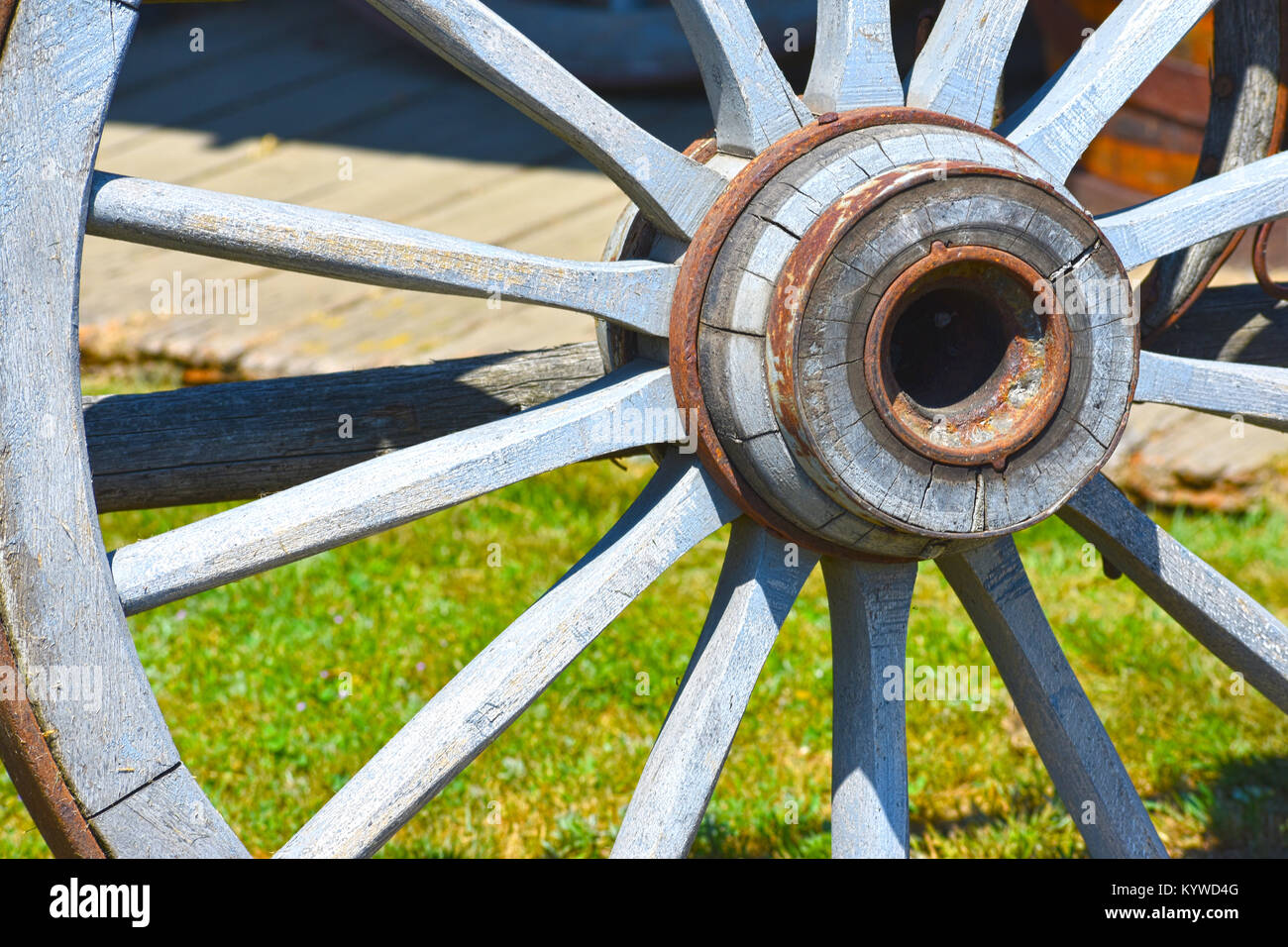Old wagon wheel in front of an old western buidling Stock Photo - Alamy