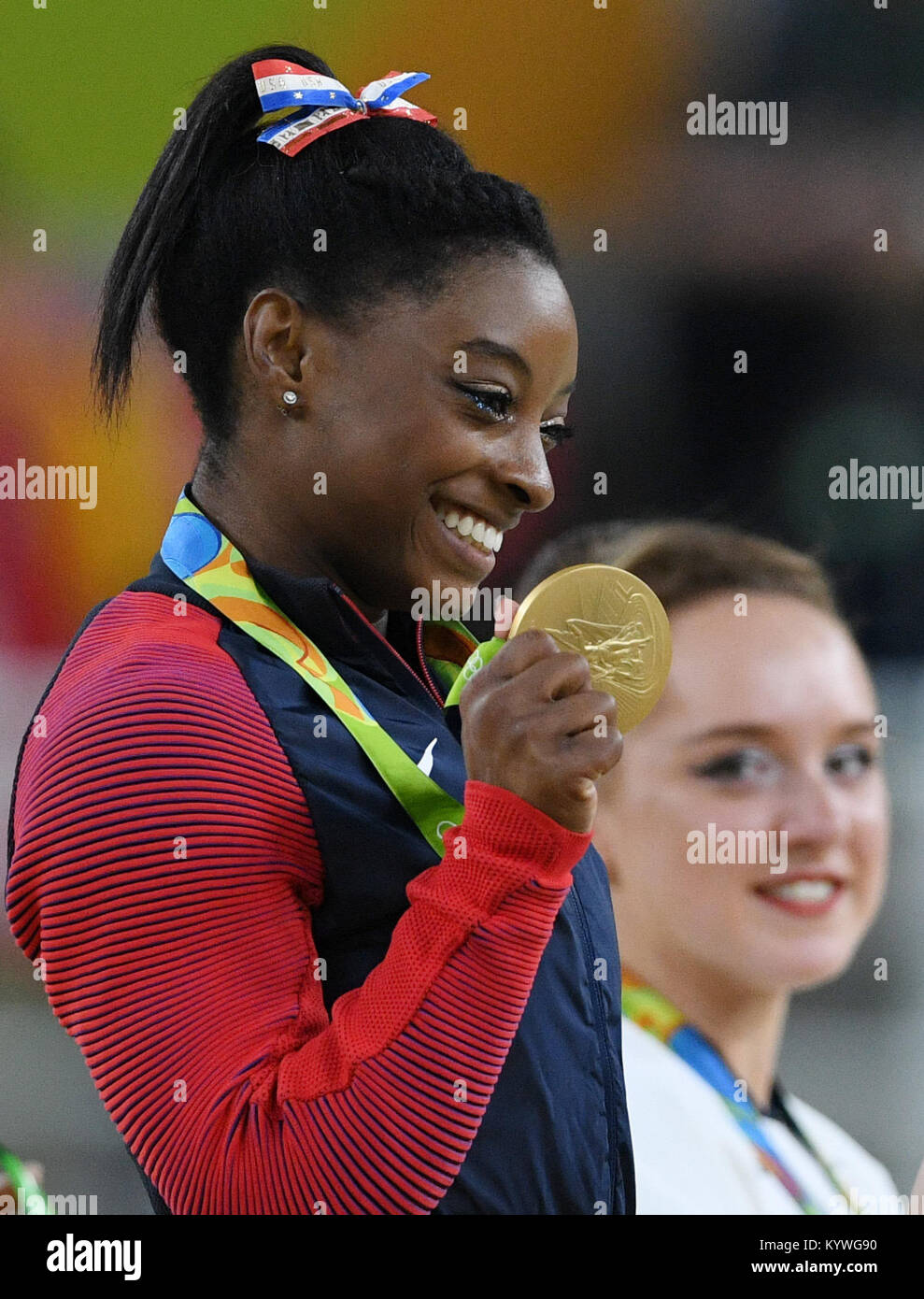 Simone Biles of the USA displays her Gold medal after the Women's Floor ...