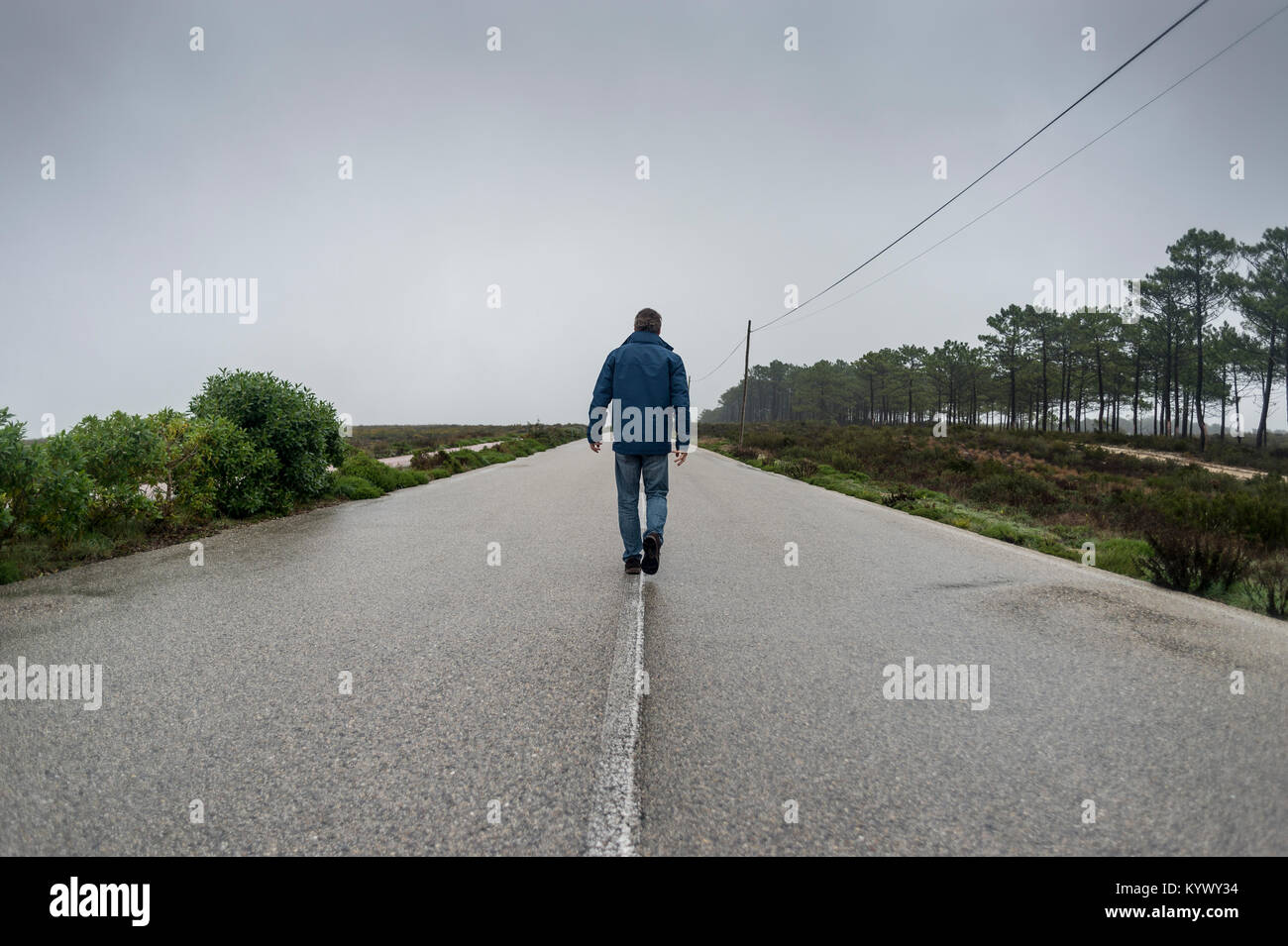 Man walking lonely road hi-res stock photography and images - Alamy